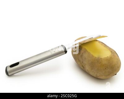 Potato With Potato Peeler Against The White Background Riga, Latvia ...