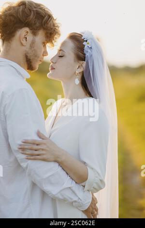 A couple shares an intimate moment, with the woman in a flowing yellow ...