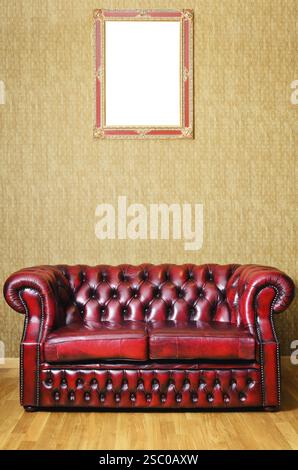 Red Genuine Leather Sofa Near The Wall Stock Photo - Alamy