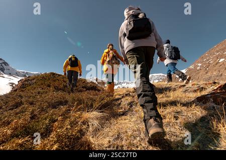 People with backpacks going on a hike through the forest in autumn ...