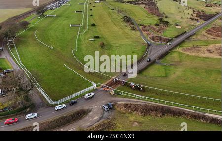 Traffic is stopped as runners and riders cross the road during the Mick ...