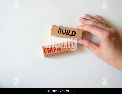Build empathy symbol. Wooden blocks with words Build empathy ...