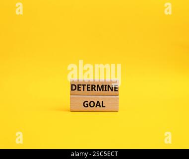 Determine goal symbol. Wooden blocks with words Determine goal ...