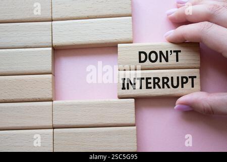 Dont interrupt symbol. Concept word Dont interrupt on wooden blocks ...