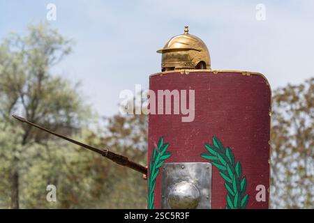 A detailed view of a Roman legionnaire's shield and golden helmet on ...