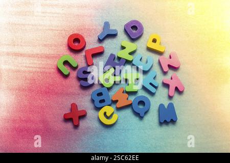 Colorful wooden letters scattered on a white background Stock Photo - Alamy