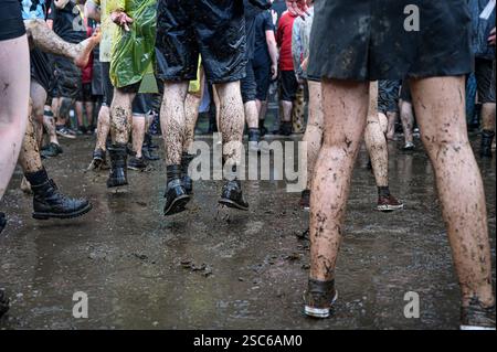 Dirty legs of people dancing in the mud during concert Stock Photo - Alamy