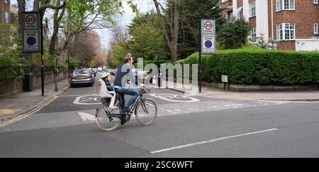 An England fan on a bike cycles past BOXPark Wembley, London. Picture ...