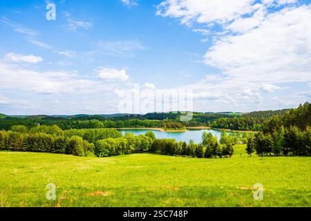 View of Jaczno lake from hill with green meadow and trees, Suwalski ...