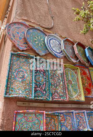 Colorful Hand-painted wooden trays and plates displayed in craft shop ...