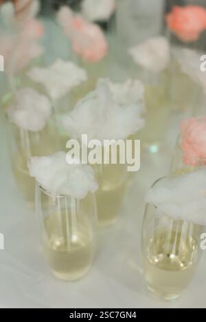 Glasses with tasty cotton candy cocktail and party hats on table Stock ...