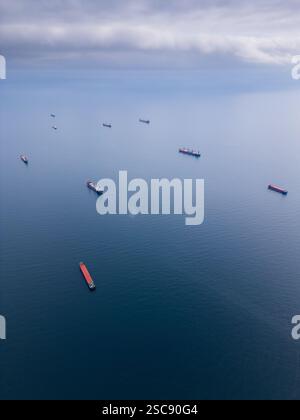 An aerial perspective of cargo ships floating on the open sea ...