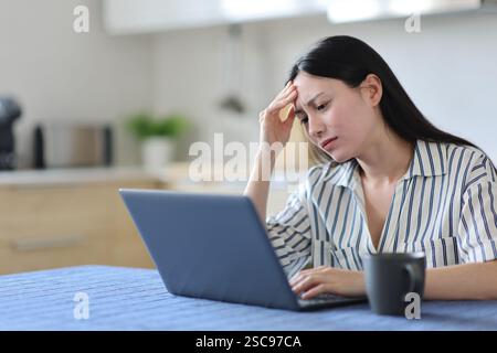 Worried and concerned asian girl in cute dress frowning, pointing and ...