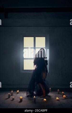 Exorcism. Terrifying shouting woman with dark hair, covered with ...