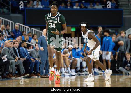 UCLA forward Xavier Booker (1) celebrates with fans after the team ...