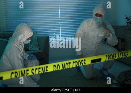 Forensic experts working at crime scene indoors Stock Photo - Alamy