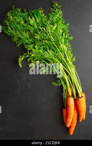 Cut ripe raw orange carrot into slices on kitchen wooden board. Sliced ...