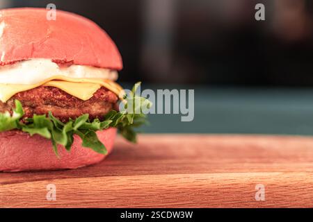 Tasty burger with bacon on pink background Stock Photo - Alamy