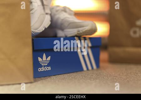 Cardboard box with blue sneakers on pink background Stock Photo - Alamy