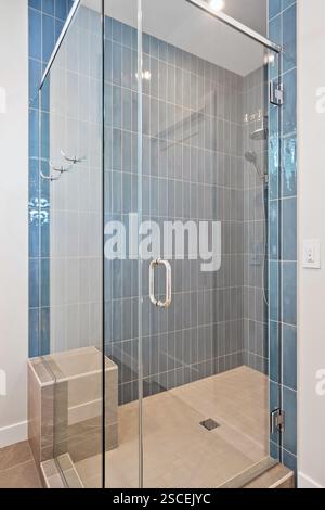 Bright bathroom with shower, shower head, light tile Stock Photo - Alamy