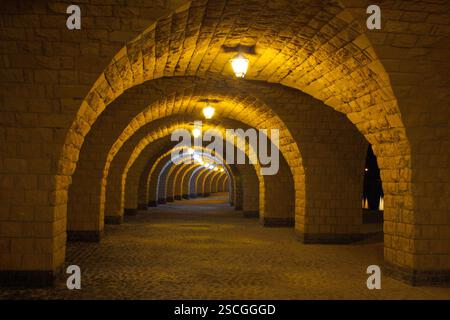 The arched stone colonnade with suspended lanterns Stock Photo - Alamy