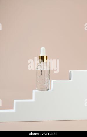 Pipette with liquid transparent gel, serum or essential oil on yellow ...