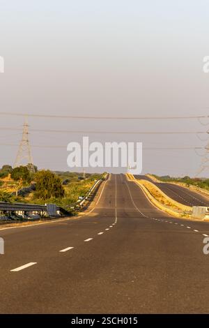 isolated countryside tarmac road with bright blue sky at morning from ...