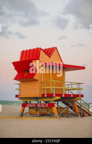 Scenic view of an iconic yellow lifeguard tower with yellow flag on ...