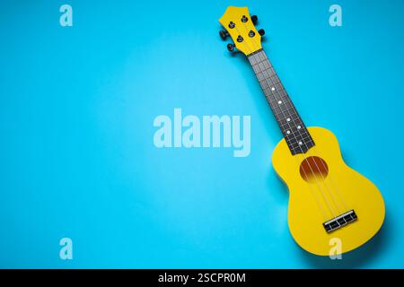 One ukulele on light blue background, top view. Space for text Stock ...