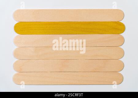 six wooden sticks, one with yellow color on a white background Stock ...