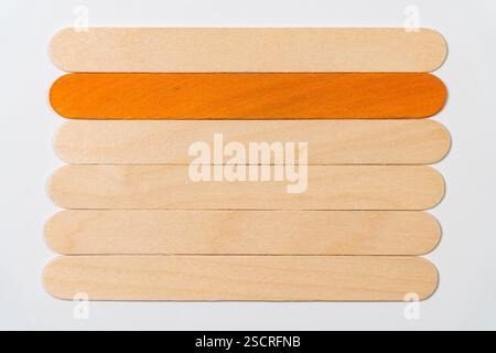 six wooden sticks, one with color on a white background Stock Photo - Alamy