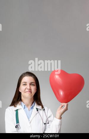 Love, woman doctor with heart balloon and against a white background ...
