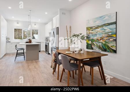 Wooden table and comfortable chairs placed near kitchen furniture in ...