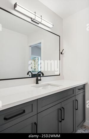 Modern bathroom with white glass countertop, black taps, recessed ...