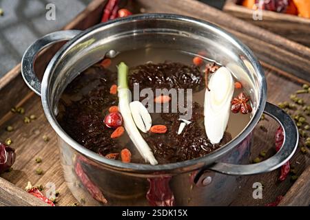 Mini hot pot soup base tomato mushroom soup base Stock Photo - Alamy