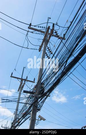 Intertwining of many electrical wires on poles Stock Photo - Alamy