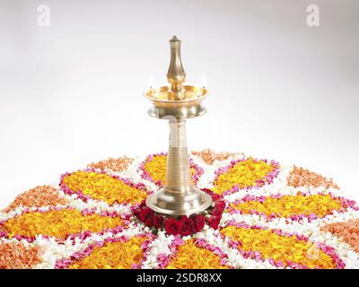 Onam Kerala festival, diya with flower design Stock Photo - Alamy