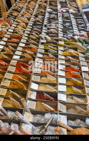 Collection of different spices in old clay bowls in colorful oriental ...
