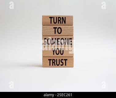 Turn to Someone you trust symbol. Wooden blocks with words Turn to ...