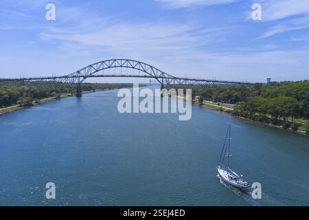 Aerial shot of yacht sailing over Cape Cod Canal near Bourne bridge ...