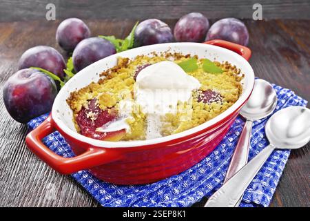 Crumble with plum in brazier on wooden board Stock Photo - Alamy