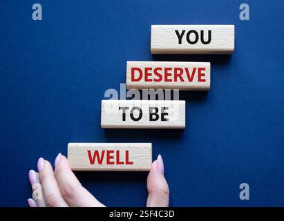 You deserve to be well symbol. Wooden blocks with words You deserve to ...