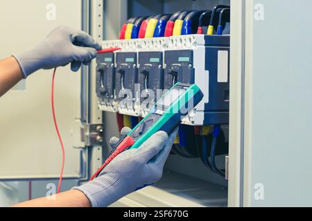 Electrical engineer inspects electrical control equipment Stock Photo ...