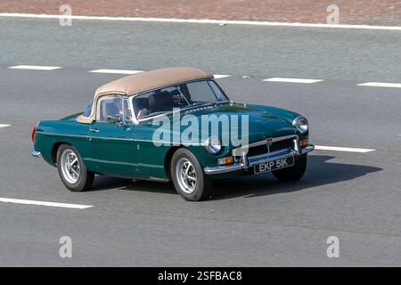 1971 70s seventies Green MG B 1798cc petrol; Vehicular traffic moving ...