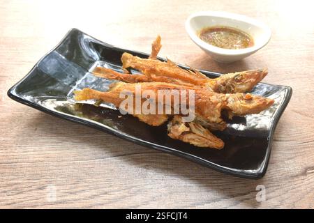 crispy fried sand whiting fish arranging on plate dipping spicy chili ...