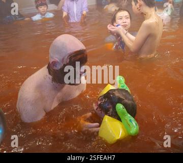 Hakone, Japan. 09th Feb, 2025. Bathers enjoy in a chocolate bath at the ...