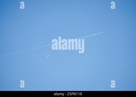 Airbus A380 and a twin engined jet liner aircraft in deep blue sky ...