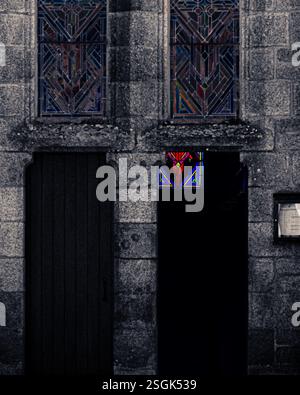 Historic stone church doorway illuminated at night in Acebo Spain ...