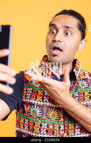 Portrait of dumbstruck man confused about friend over stupid arguments ...