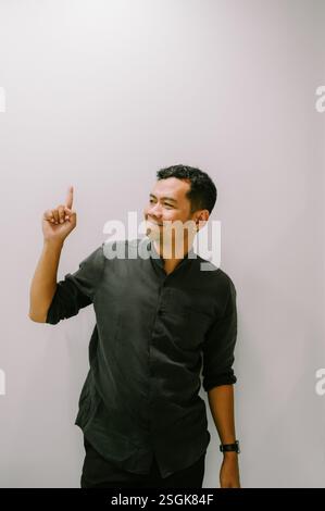 A man points with his finger, directing attention or giving ...